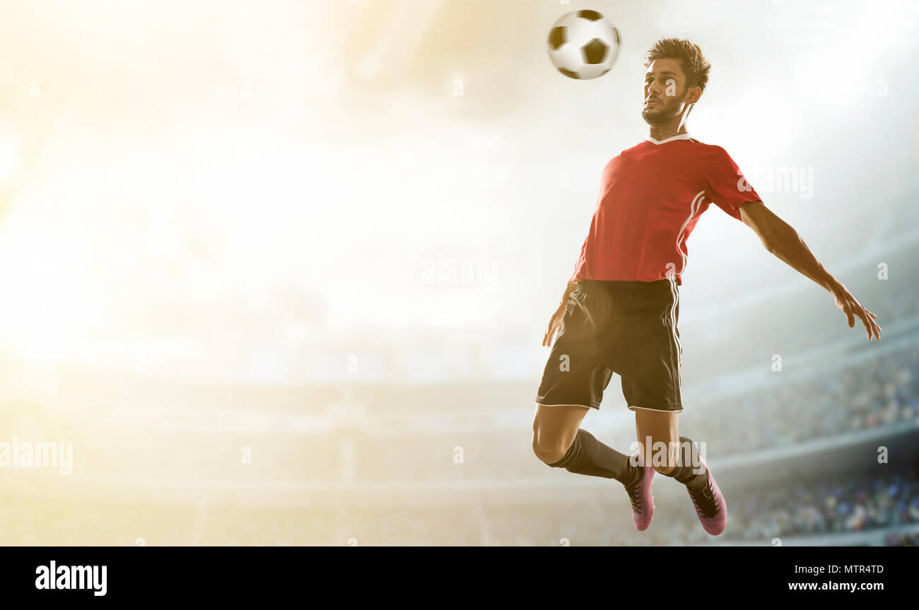 Football player landing ball on his chest in stadium Stock Photo - Alamy