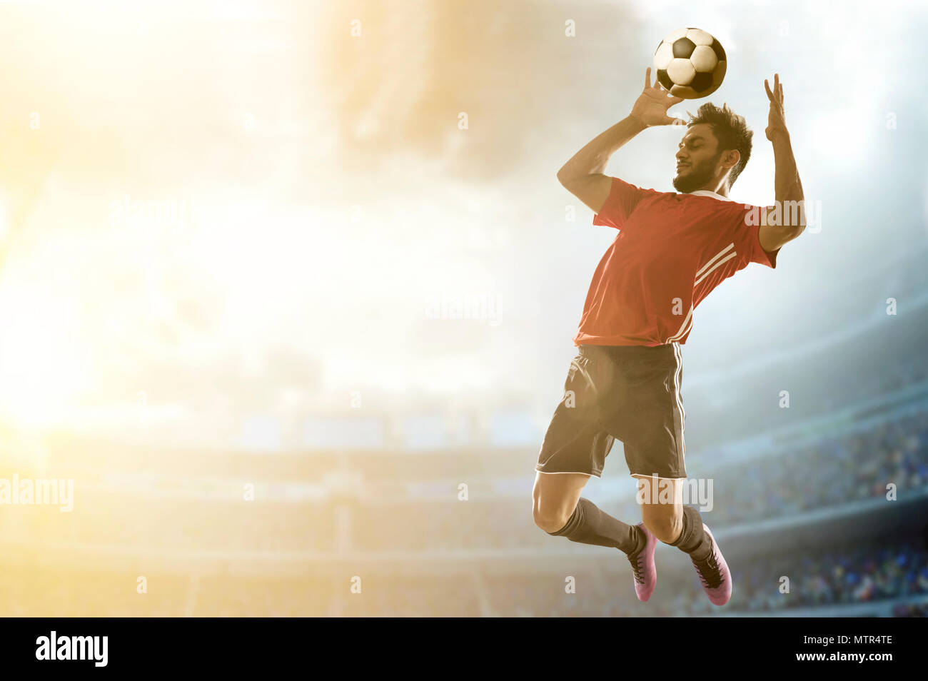 Football player landing ball on his chest in stadium Stock Photo - Alamy