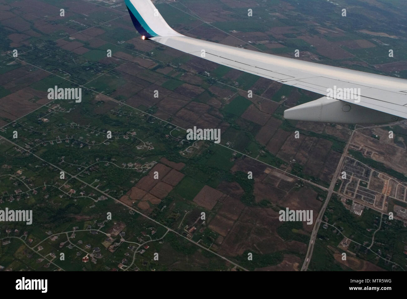 Westjet airplane wing photo taken from a passenger window Stock Photo ...