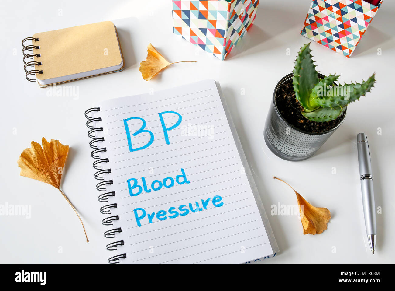 BP Blood Pressure written in notebook on white table Stock Photo - Alamy