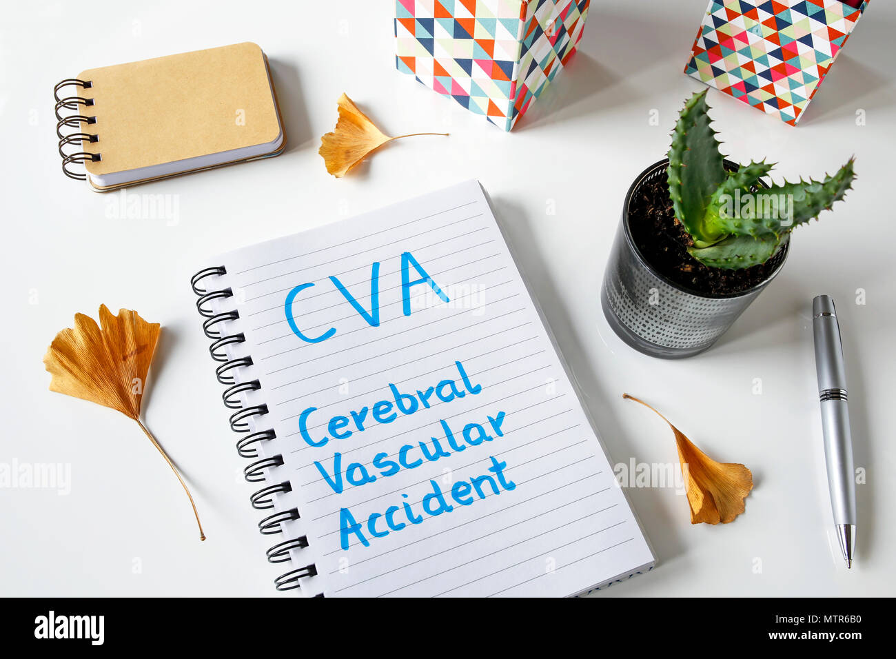 CVA Cerebral Vascular Accident written in a notebook on white table ...