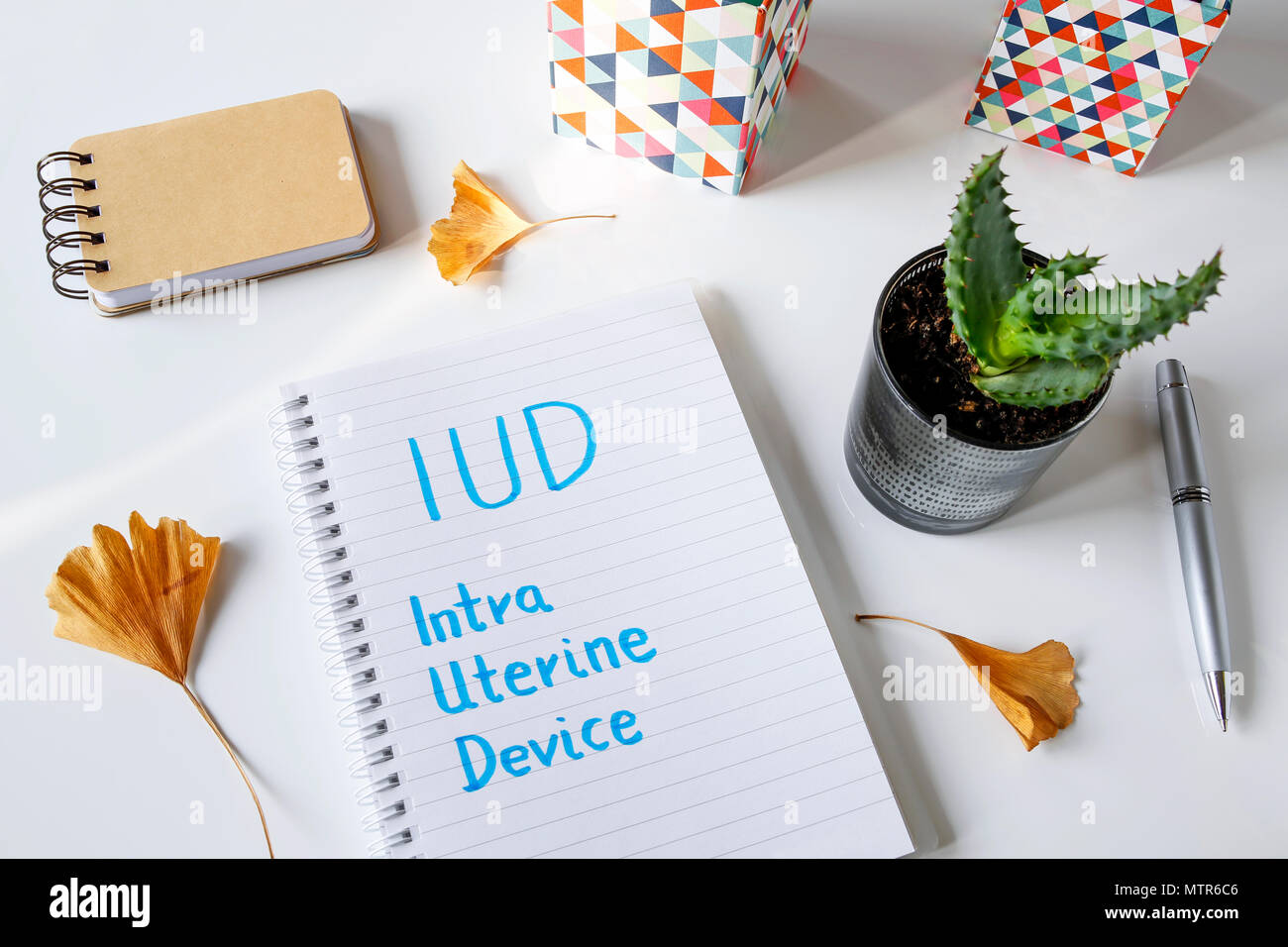 IUD intra uterine device written in a notebook on white table Stock ...