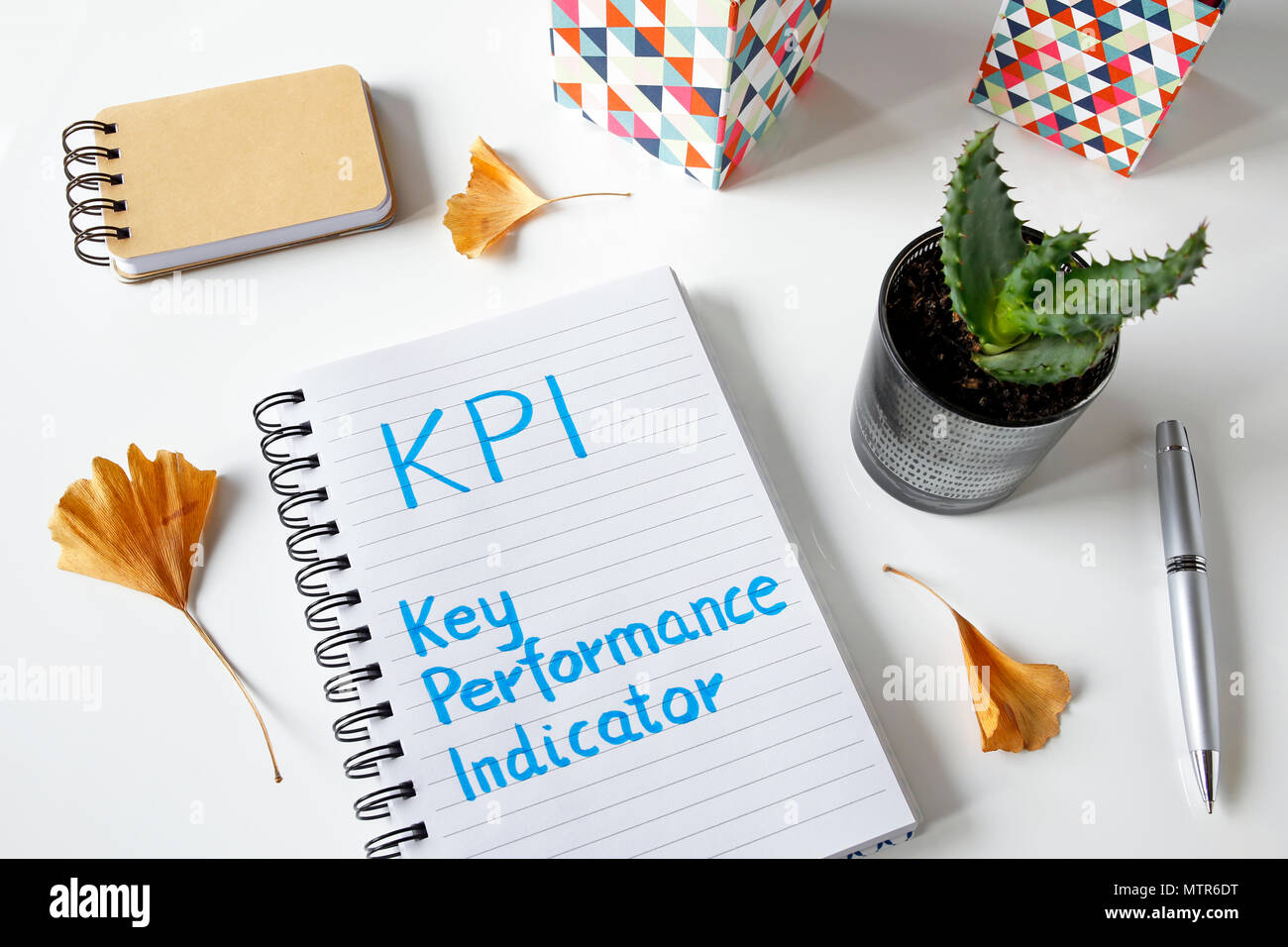 KPI key performance indicator written in a notebook on white table ...