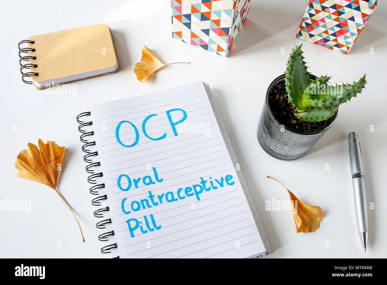 OCP Oral Contraceptive Pill written in a notebook on white table Stock Photo - Alamy