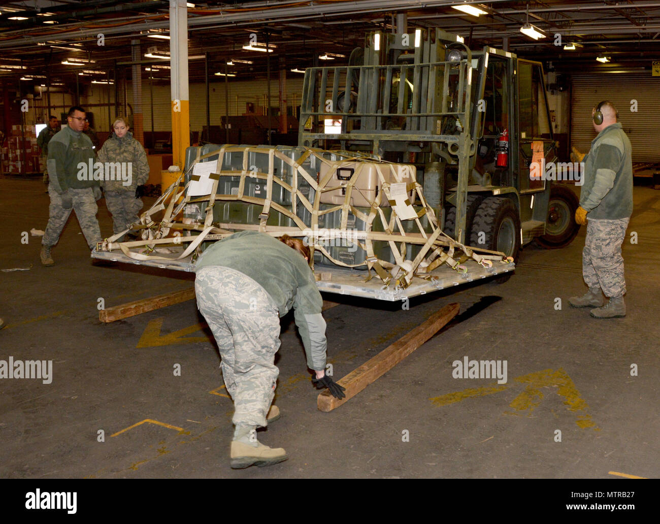Staff Sgt. Adam Sanders of the 72nd Aerial Port Squadron directs a 10K ...