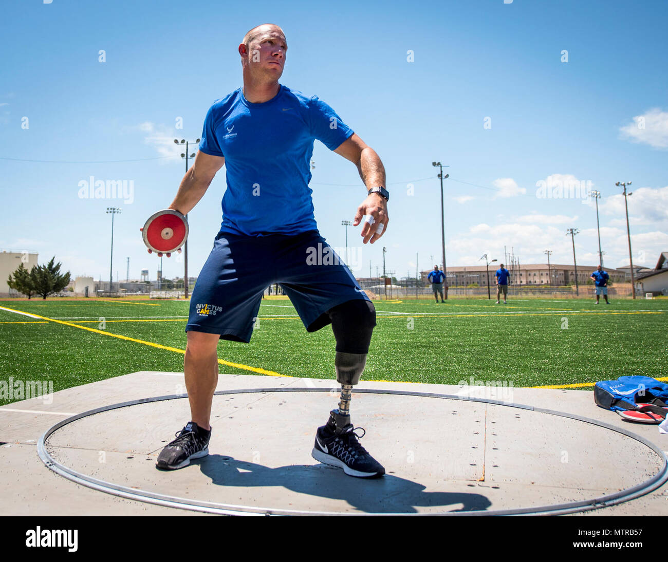 Ben Seekell, a Warrior Games athlete, begins his discus rotation during ...