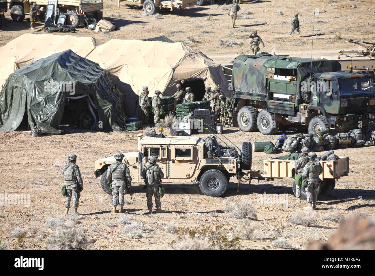 U.S. Army Soldiers from 1/25th Infantry Division work to erect the ...