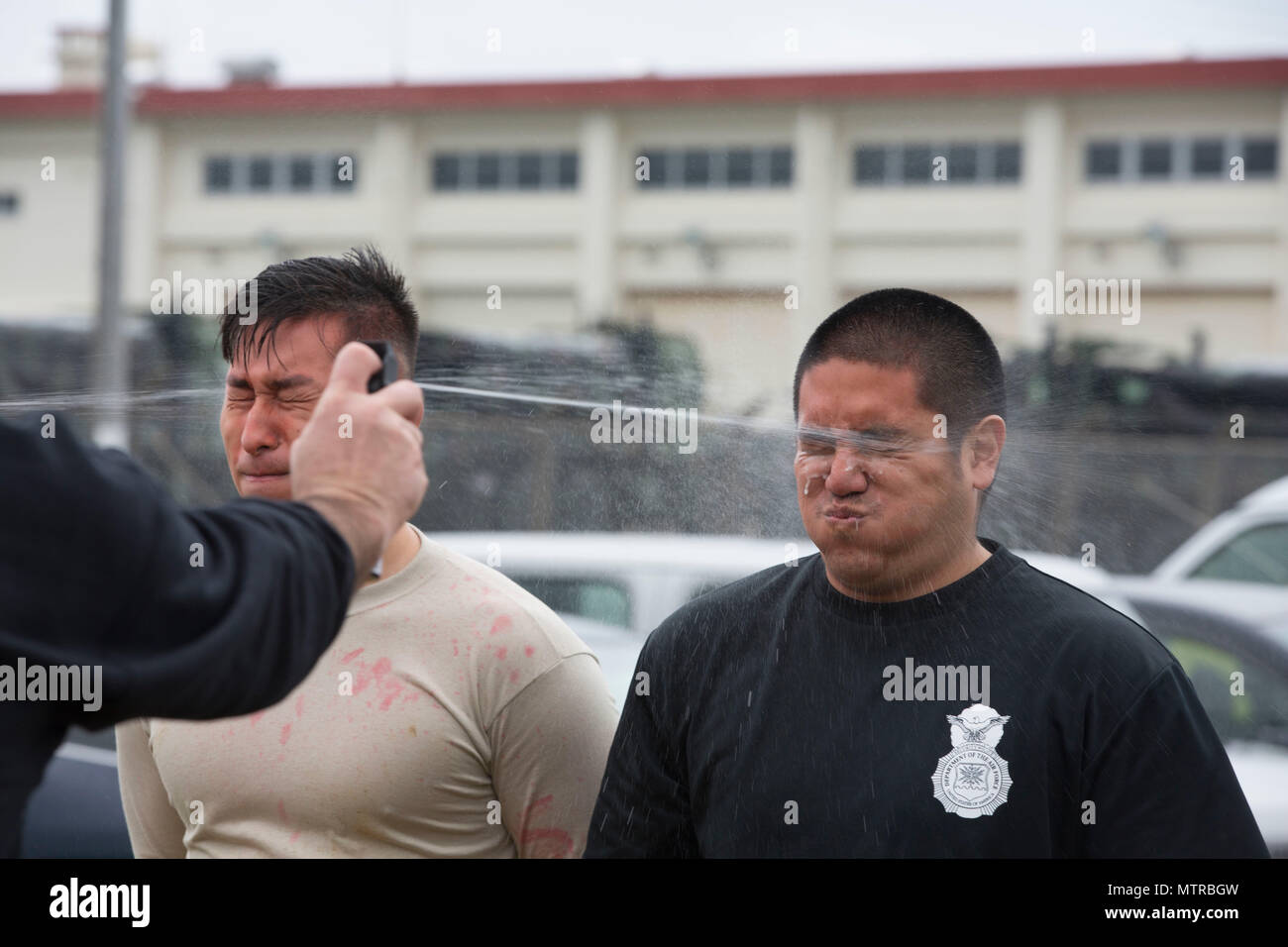 A U.S. Airmen and a Japanese Security Guard are sprayed with Oleoresin Capsaicin (OC) during the ...