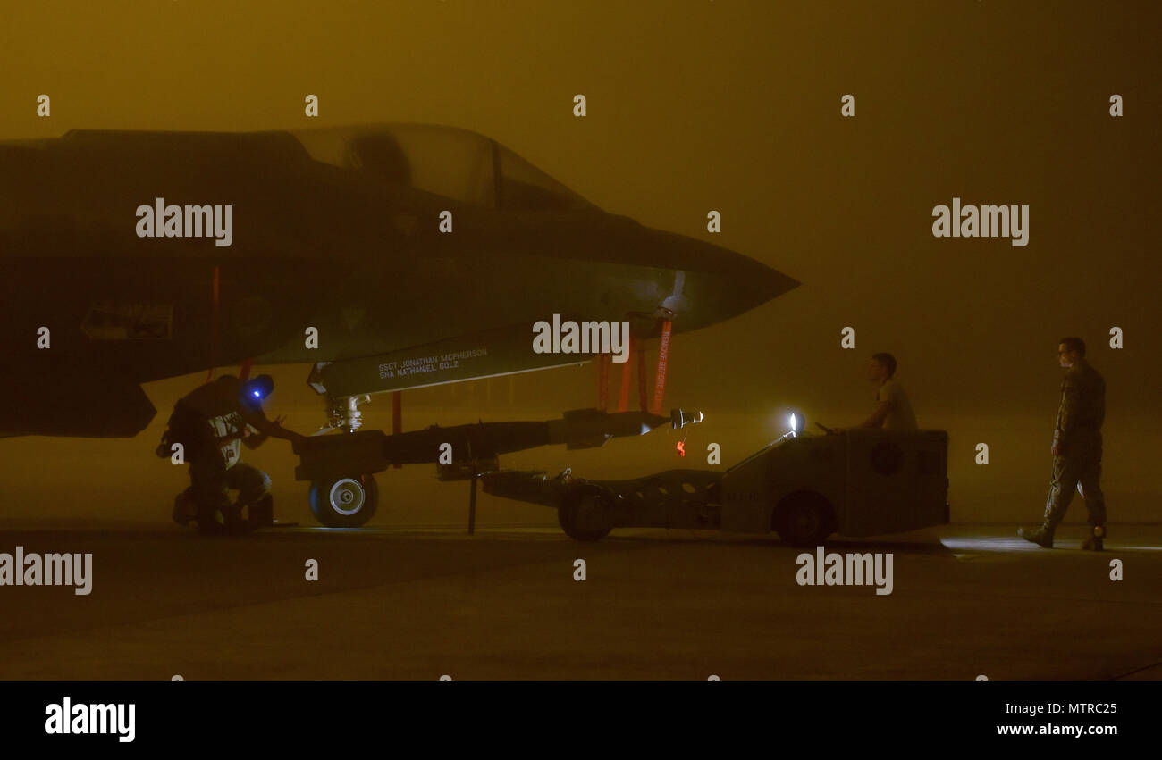 A U.S. Air Force weapons load crew assigned to the 33rd Aircraft Maintenance Squadron loads a ...