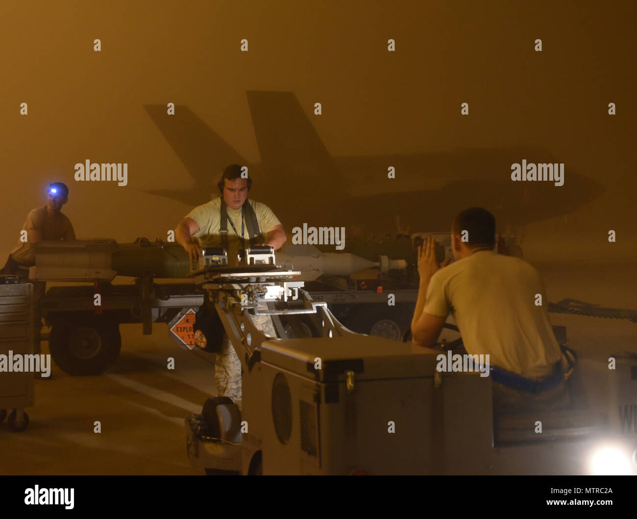 A U.S. Air Force weapons load crew assigned to the 33rd Aircraft Maintenance Squadron transports ...