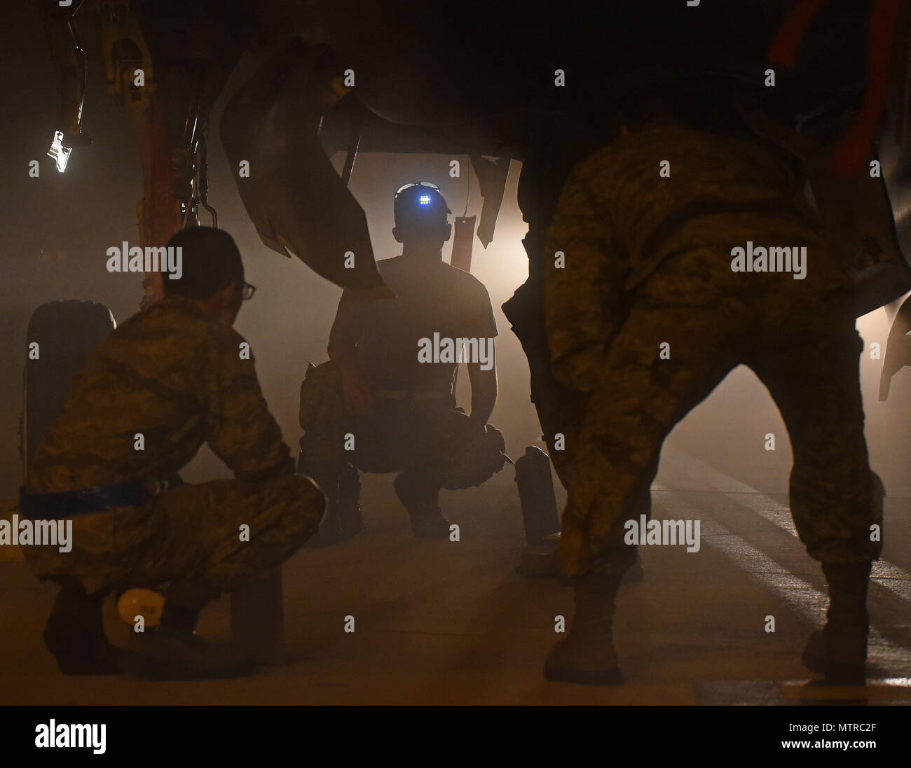 A U.S. Air Force weapons load crew assigned to the 33rd Aircraft Maintenance Squadron loads a ...