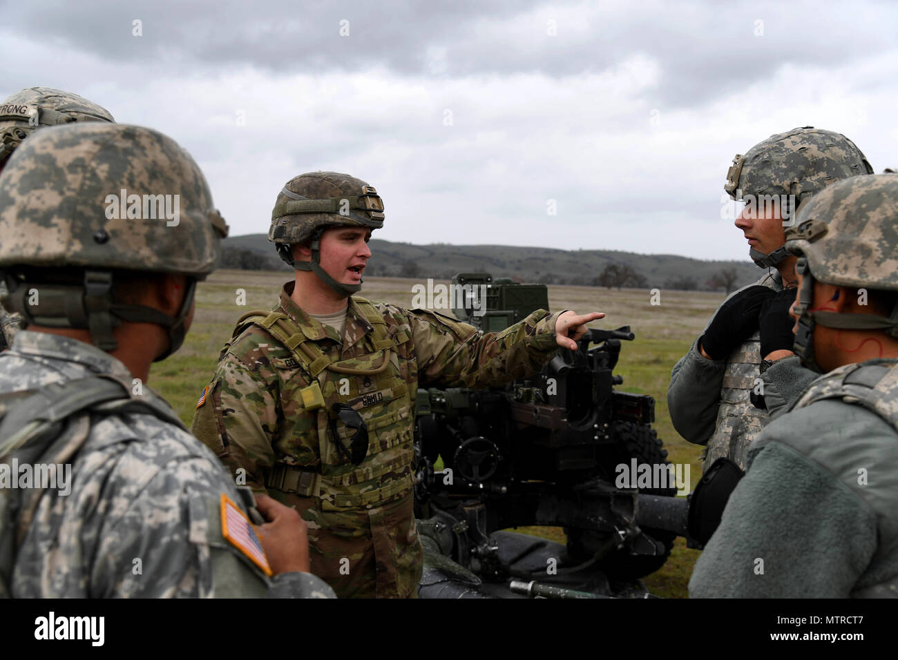 Staff Sgt. Jesse Gould briefs his gun crew assigned to both Alpha and Bravo Battery, 1-143rd ...