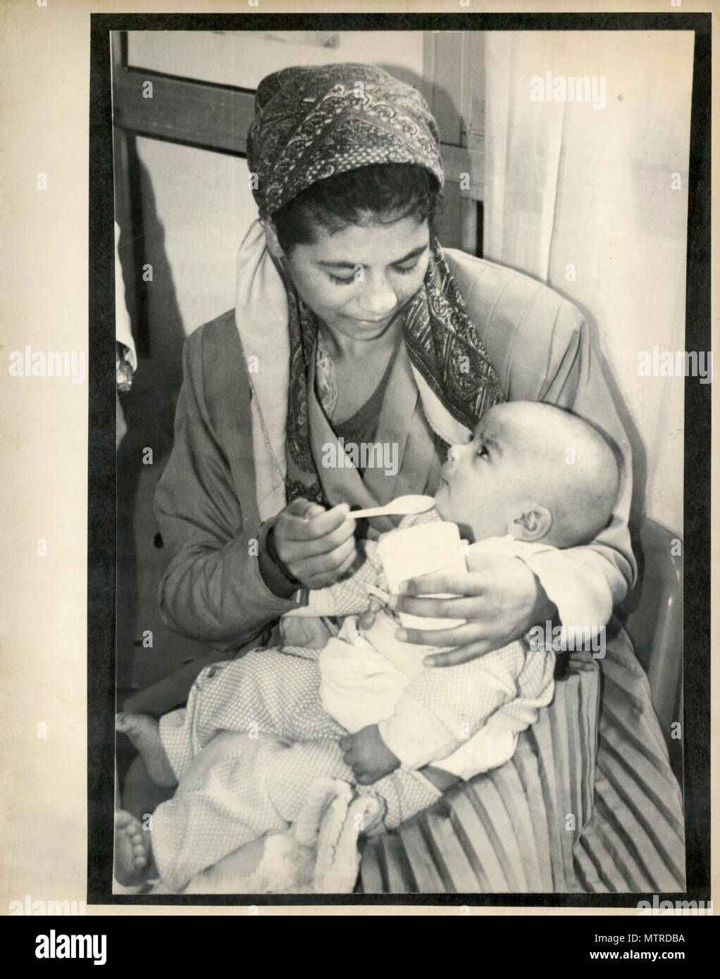 woman feeding a baby Stock Photo - Alamy