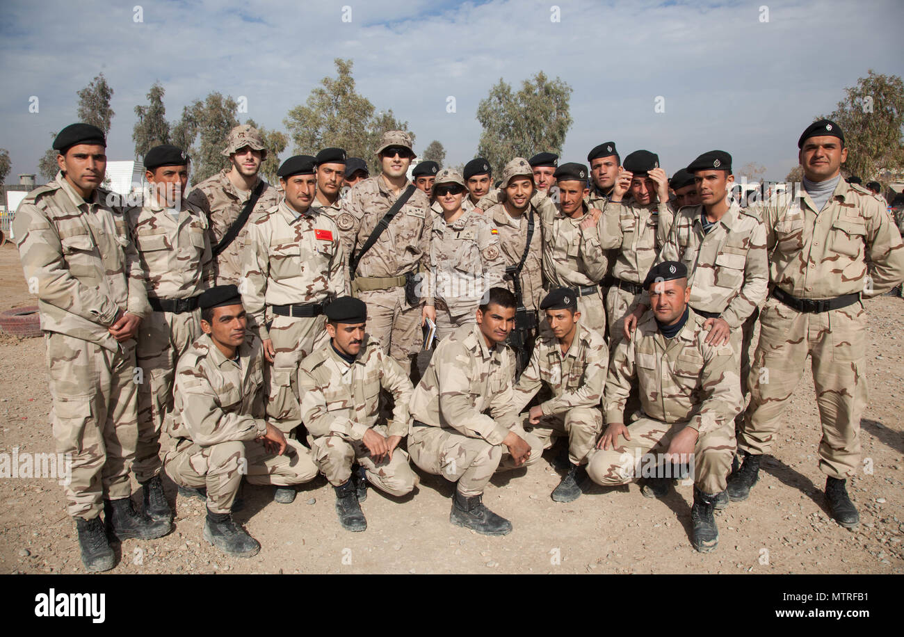 Spanish trainers and Iraqi security forces take a group photo at ...