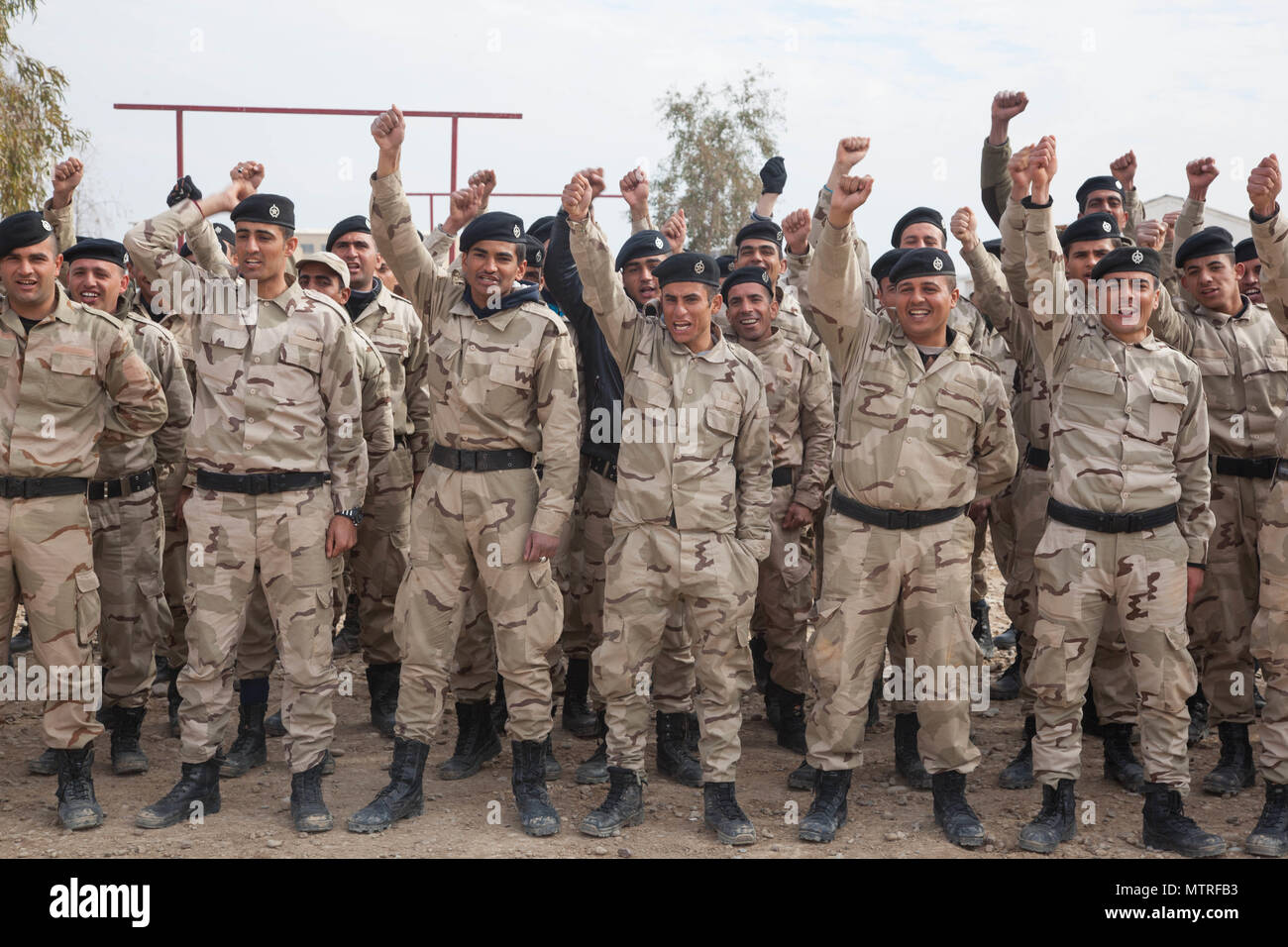 Iraqi security forces cheer on fellow soldiers at an obstacle course at ...