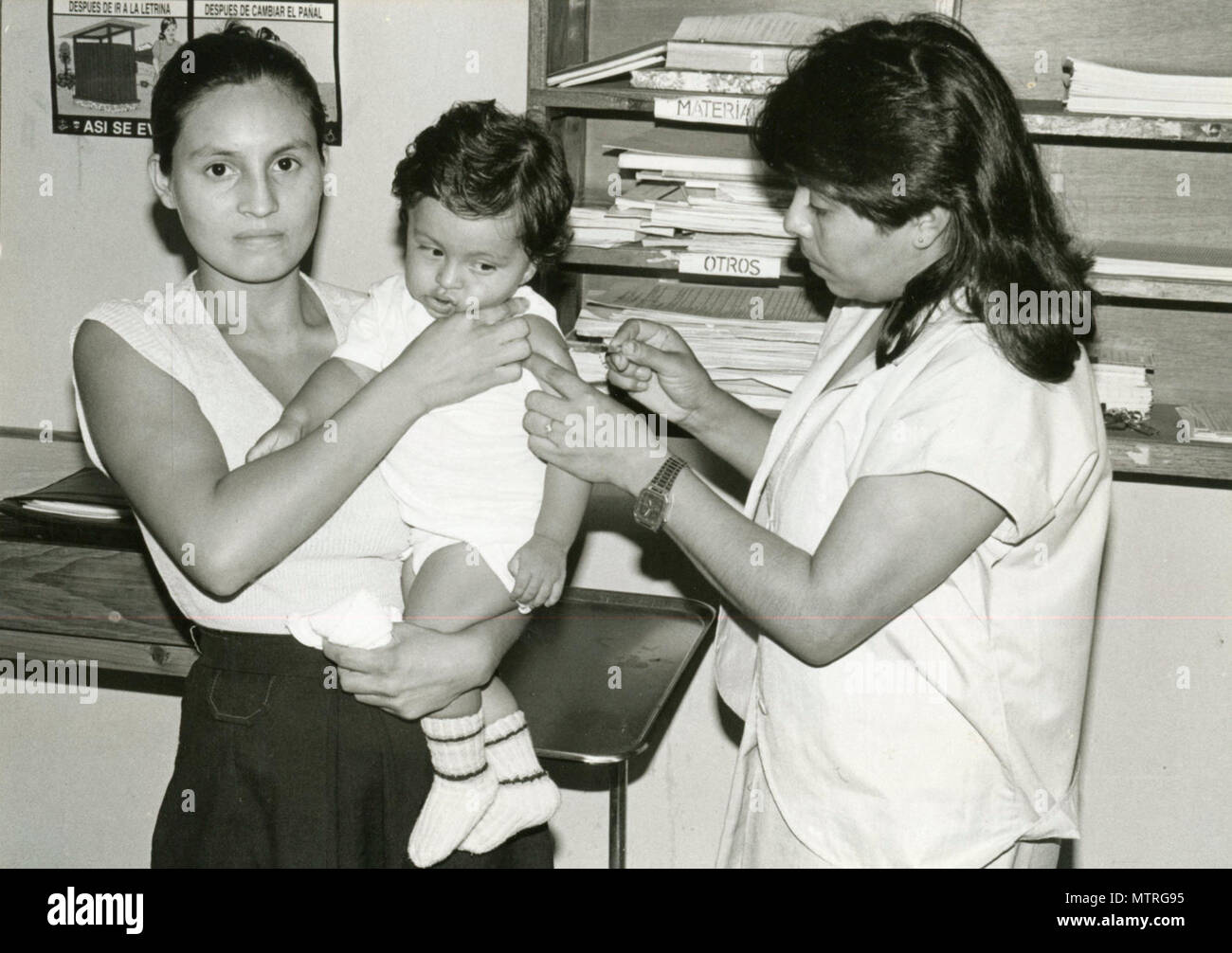 women holding a baby standing taking a picture Stock Photo - Alamy