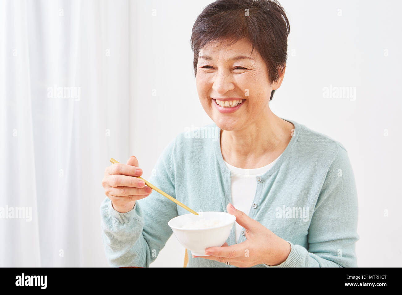 Japanese senior woman eating rice Stock Photo - Alamy