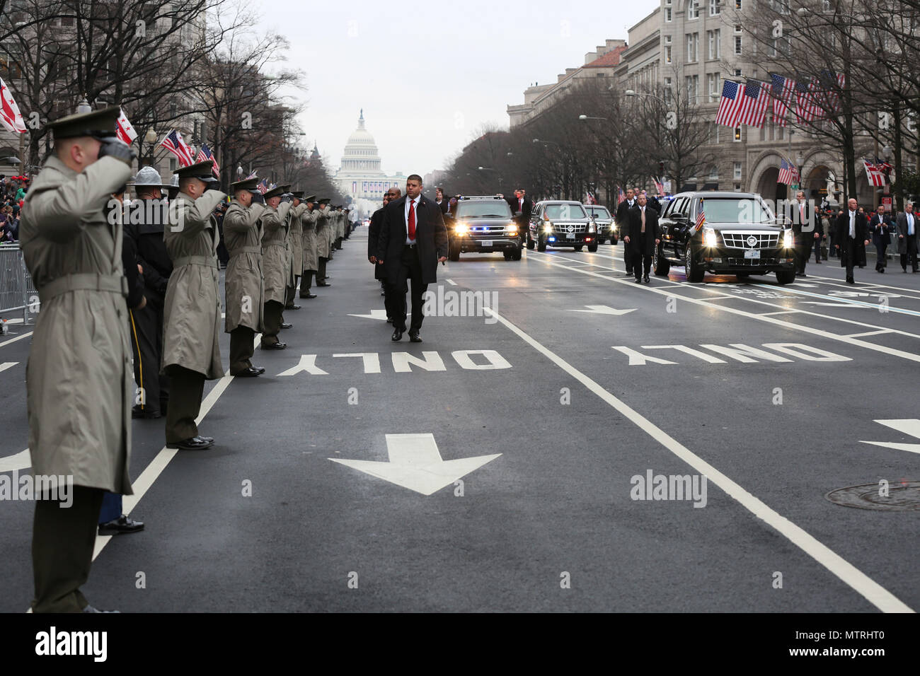 U.S. Marines salute the presidential motorcade as it passes by Freedom ...