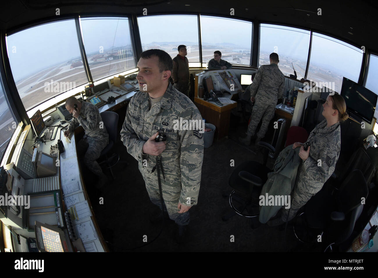 Air traffic control airmen perform operations in the airfield tower at ...