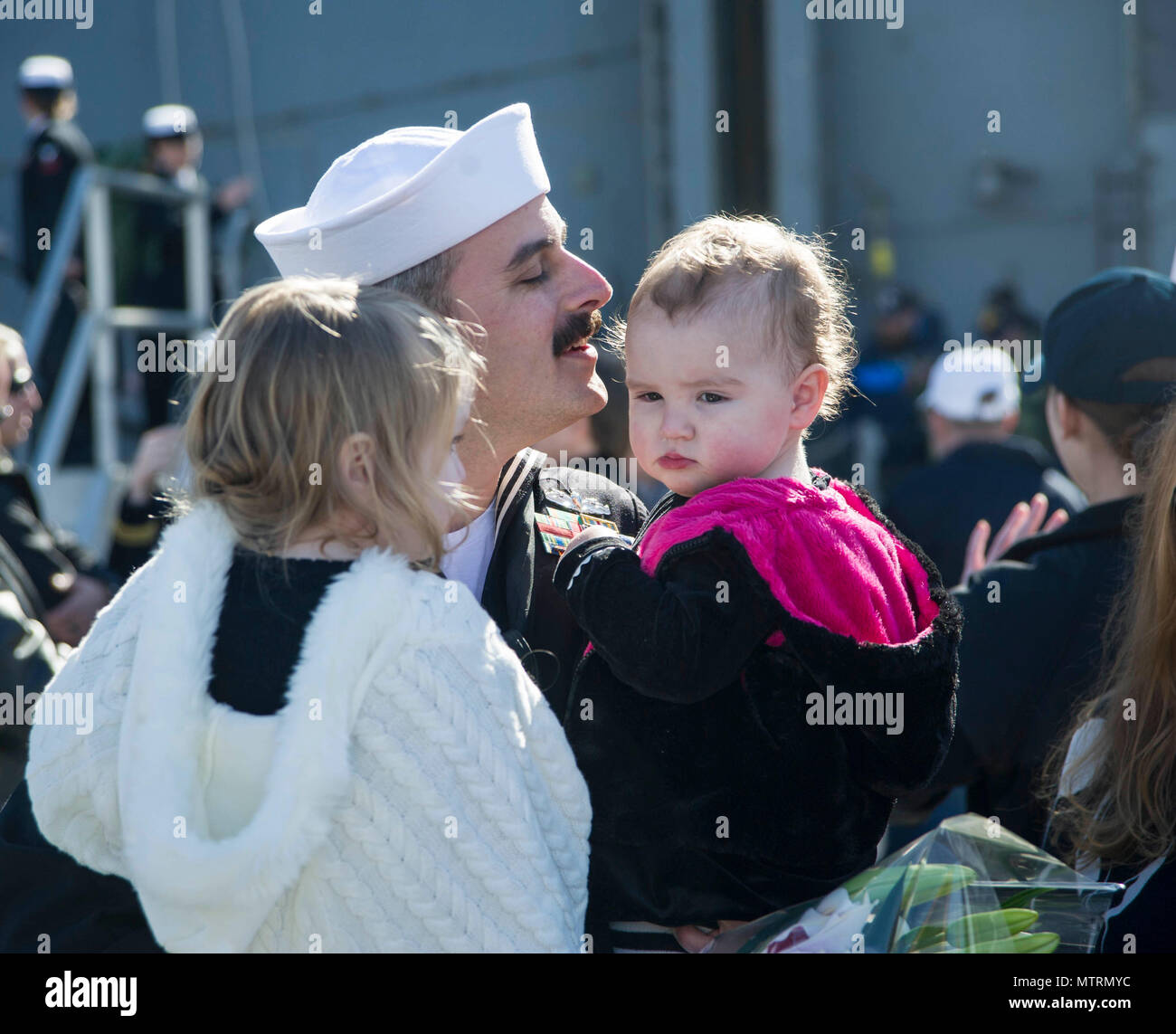 170119-N-NI420-150 NORFOLK (Jan. 19, 2017) A Sailor greets his family ...