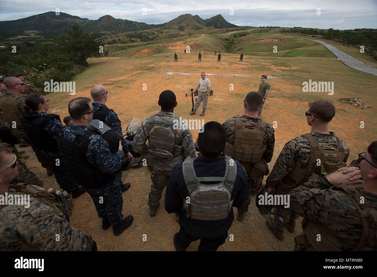 Students observe as their instructor presents them with the Mossberg 12 ...