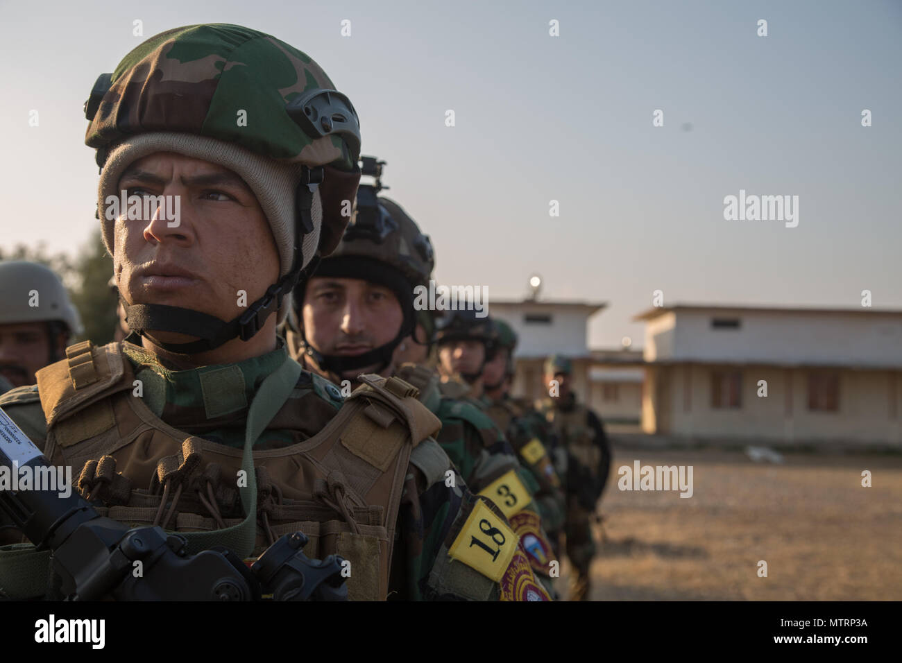 Iraqi security forces soldiers wait to begin training at Camp Taji ...