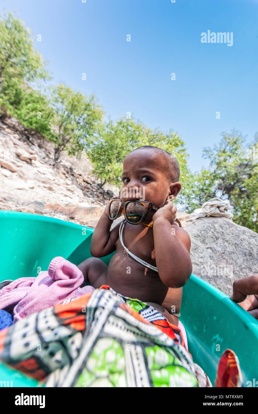 NAMIBE/ANGOLA - 28 AUG 2013 - African baby tribe playing with ...