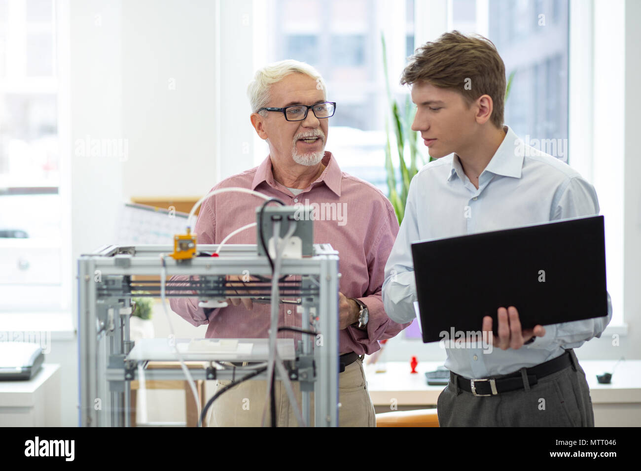 Senior engineer teaching how to change 3D printer configurations Stock ...