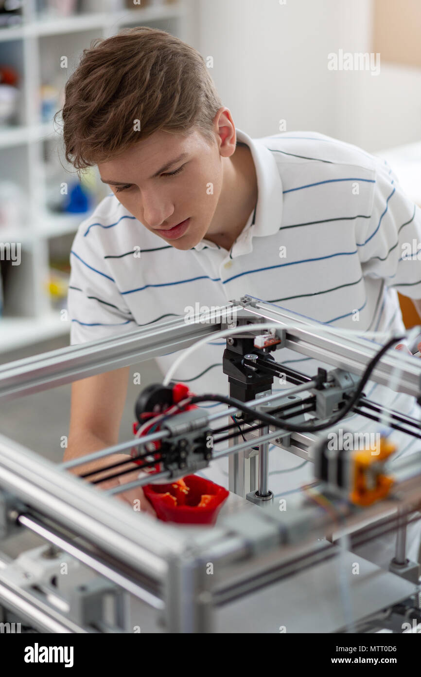 Charming young engineer creating model of bell pepper Stock Photo - Alamy