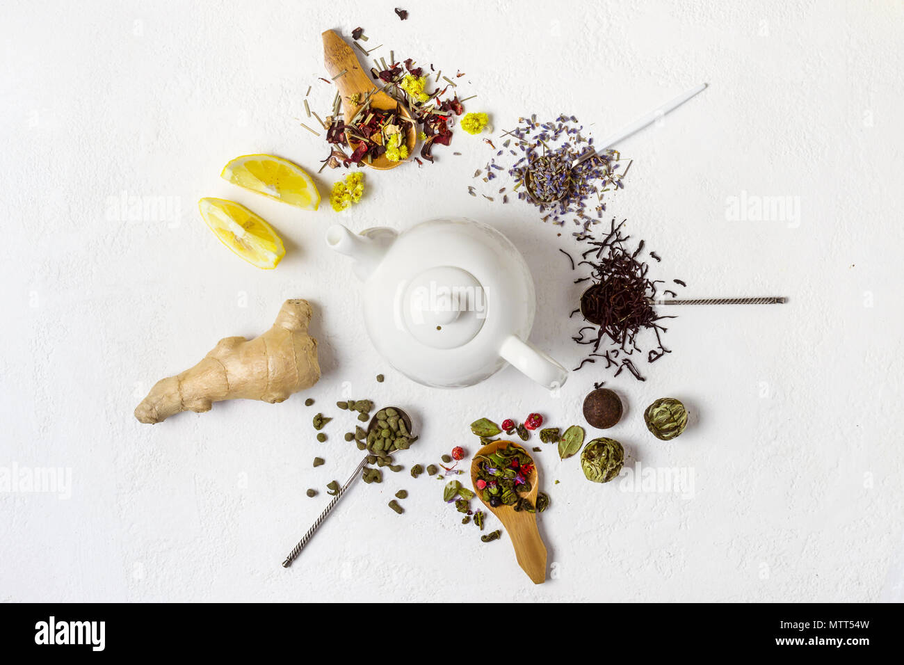 Tea concept. Selection of different varieties of tea around the teapot ...