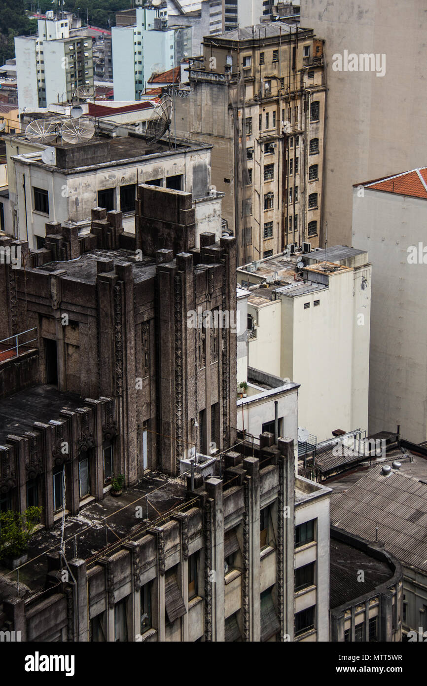 From the top of a tall tower a detail view of old aged dirty concrete ...