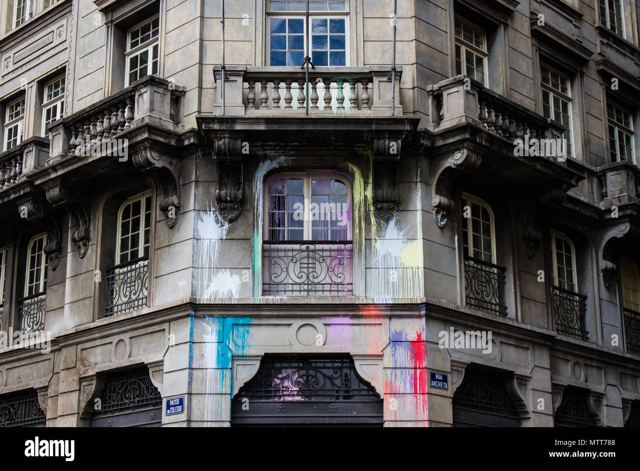 Facade of old and aged polluted building with red, green, yellow ...