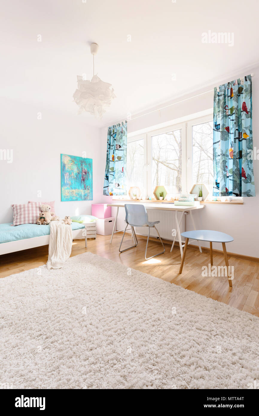 Very bright and airy room with light furniture, subtle decorations and ...