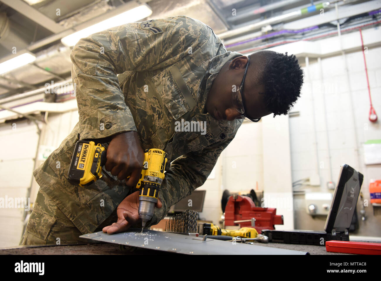 A 48th Aircraft Structural Maintenance Airman drills out a rivet on a ...