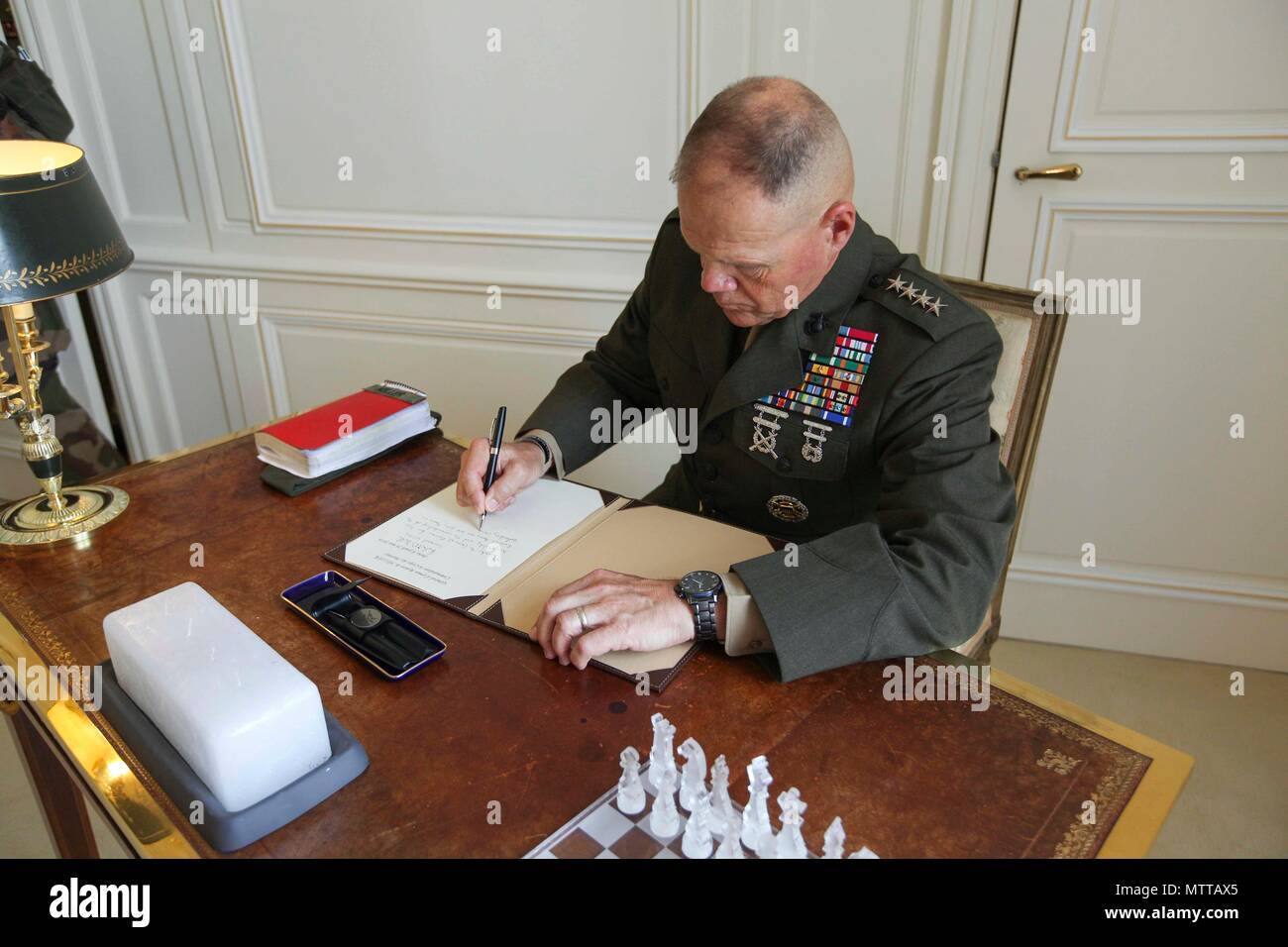 Commandant of the Marine Corps Gen. Robert B. Neller signs a guest ...