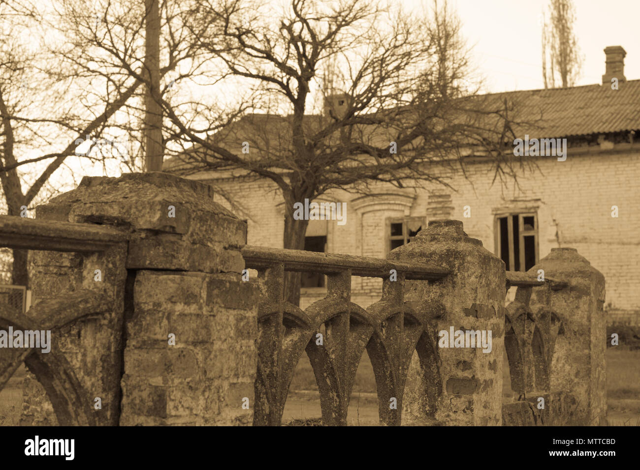 old stone fence and abandoned house in village Stock Photo - Alamy