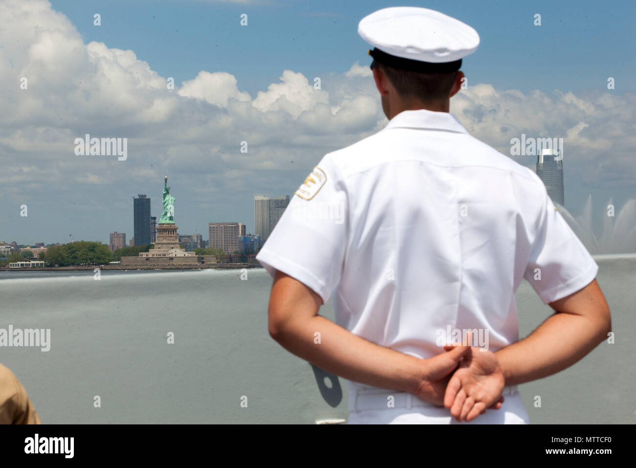 A Sea Cadet stands at parade rest aboard USS Arlington (LPD 24) during ...