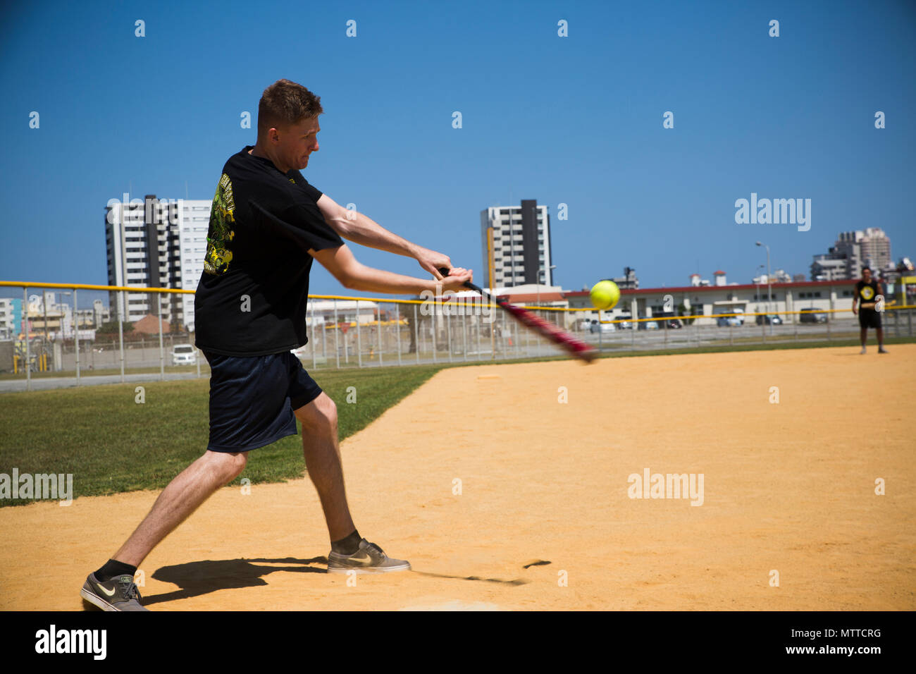 A Marine Wing Headquarters Squadron 1 Marine swings a bat during the ...