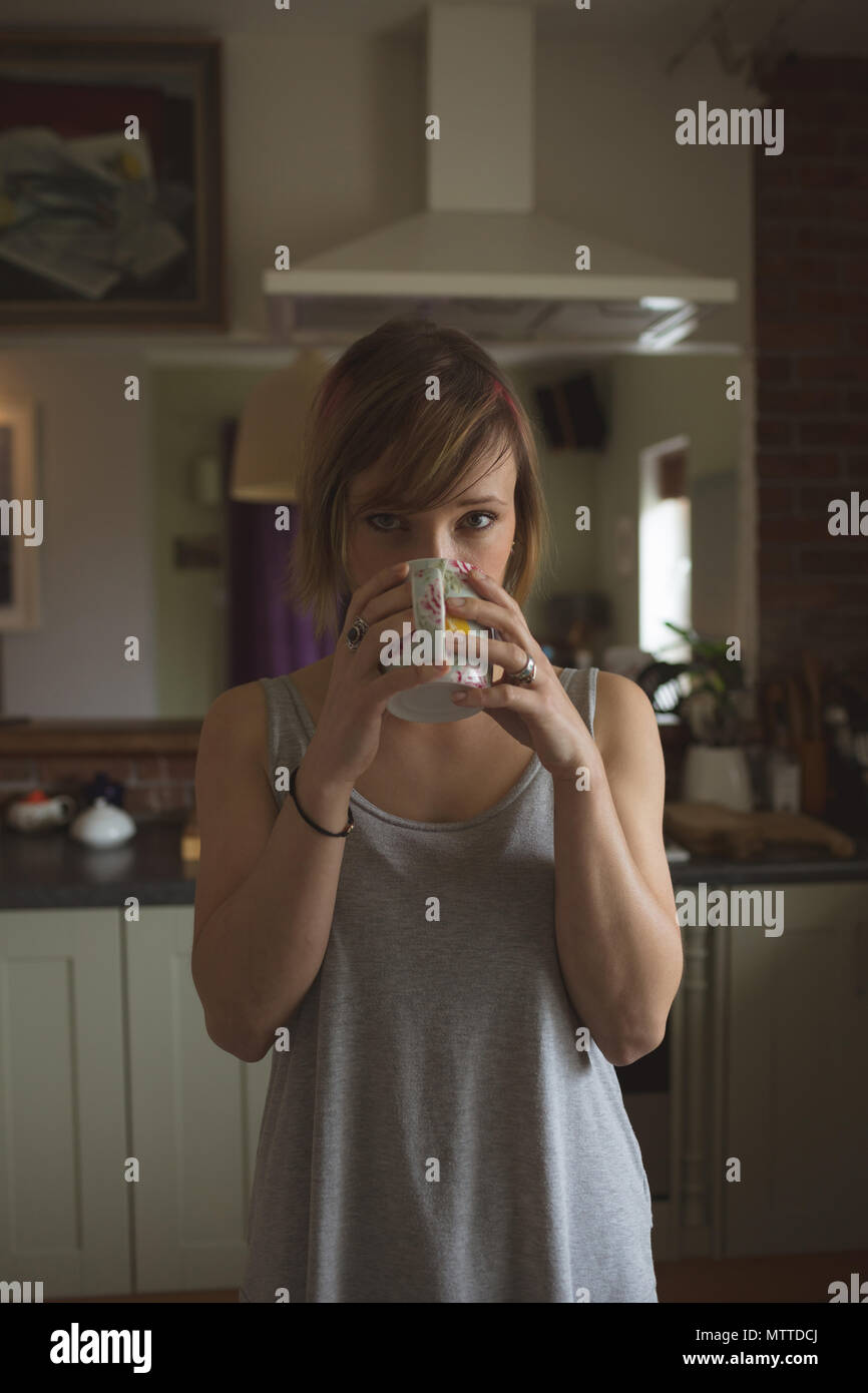 Beautiful woman drinking coffee at home Stock Photo - Alamy