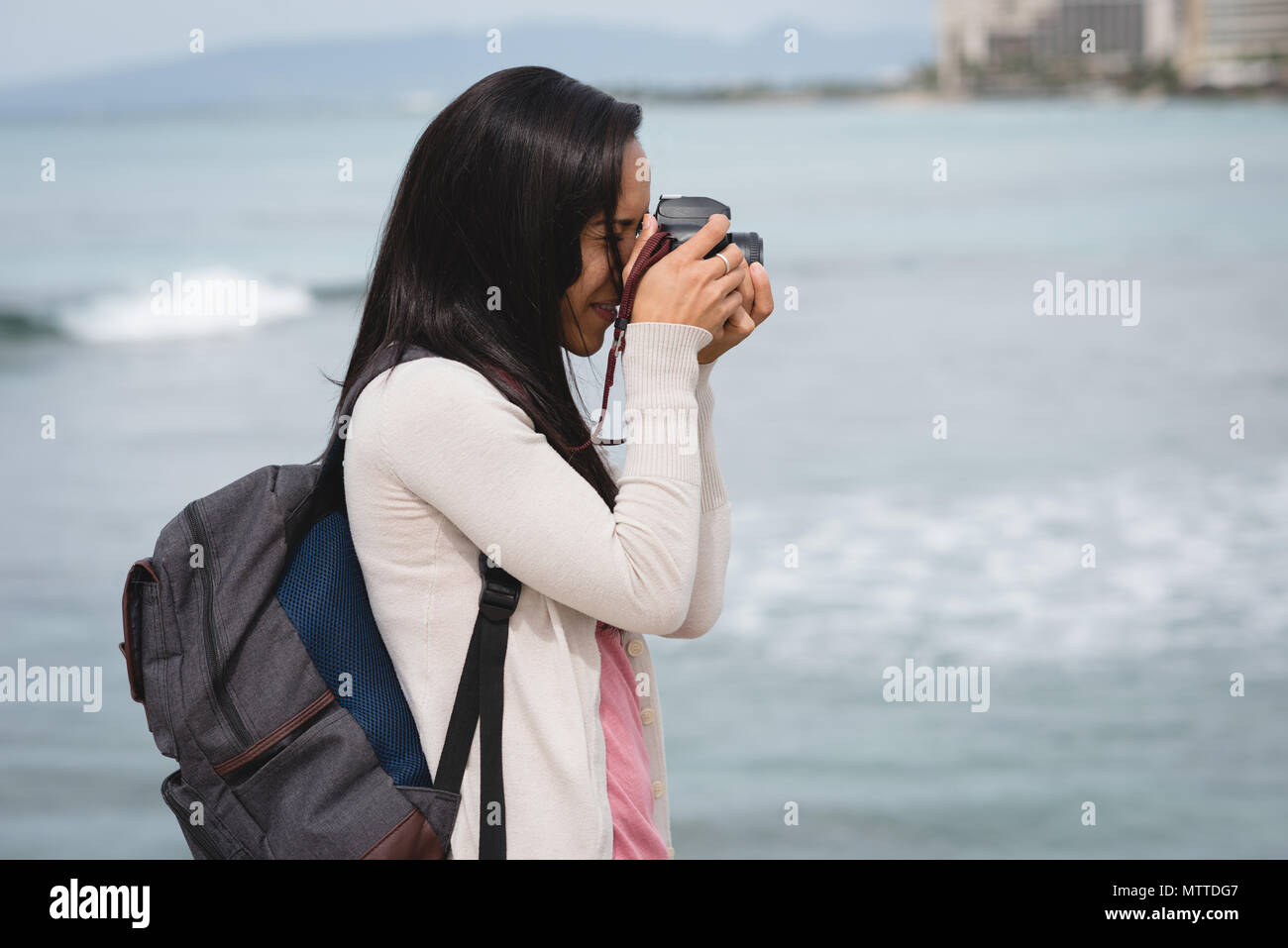 Woman photographing with digital camera at beach Stock Photo - Alamy
