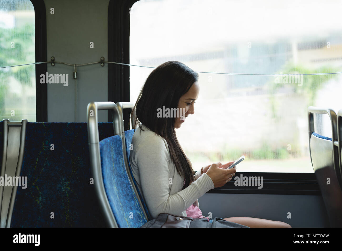 Using phone on bus hi-res stock photography and images - Alamy
