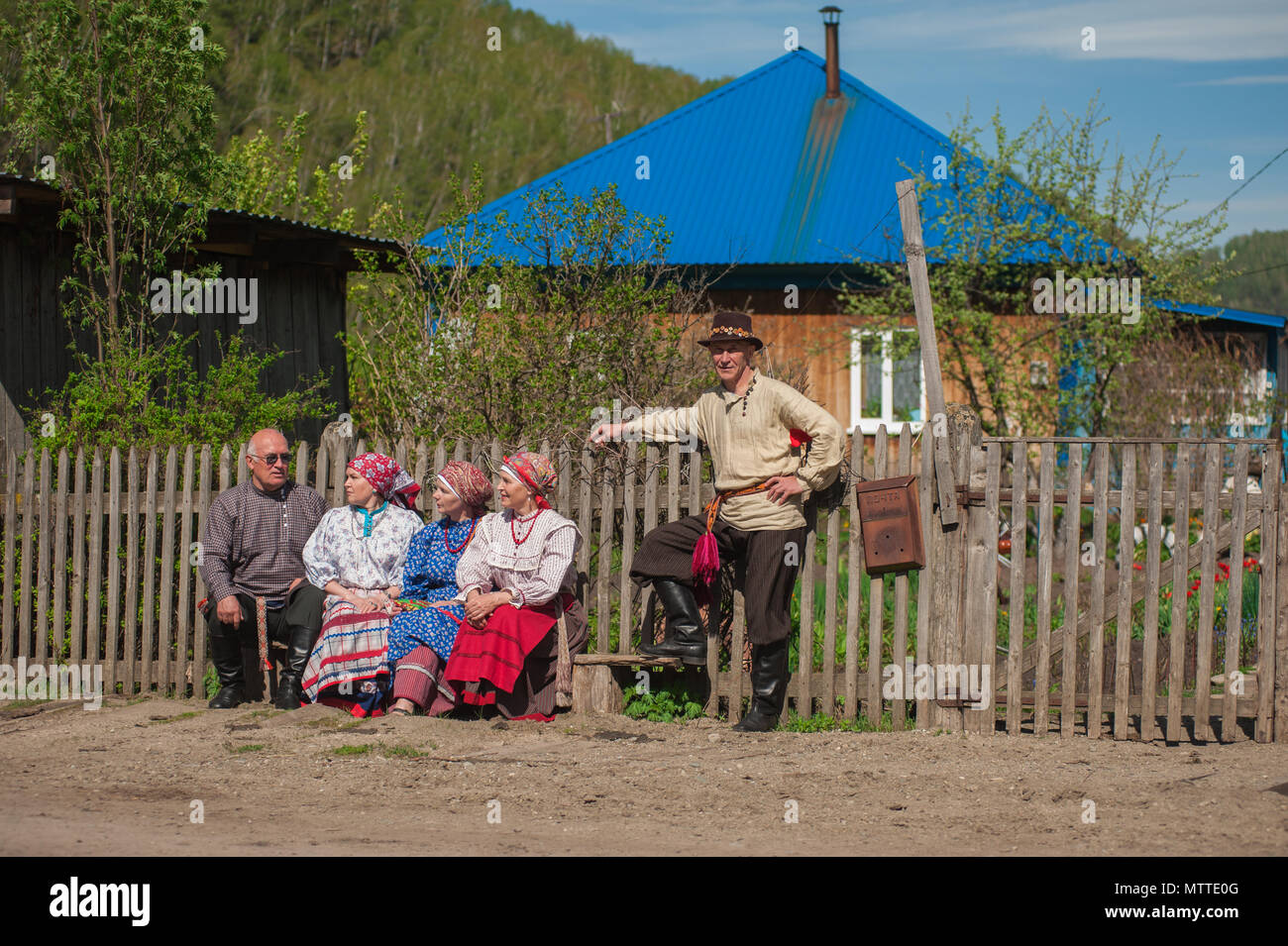 Villagers in traditional costumes are waiting for the beginning of the ...