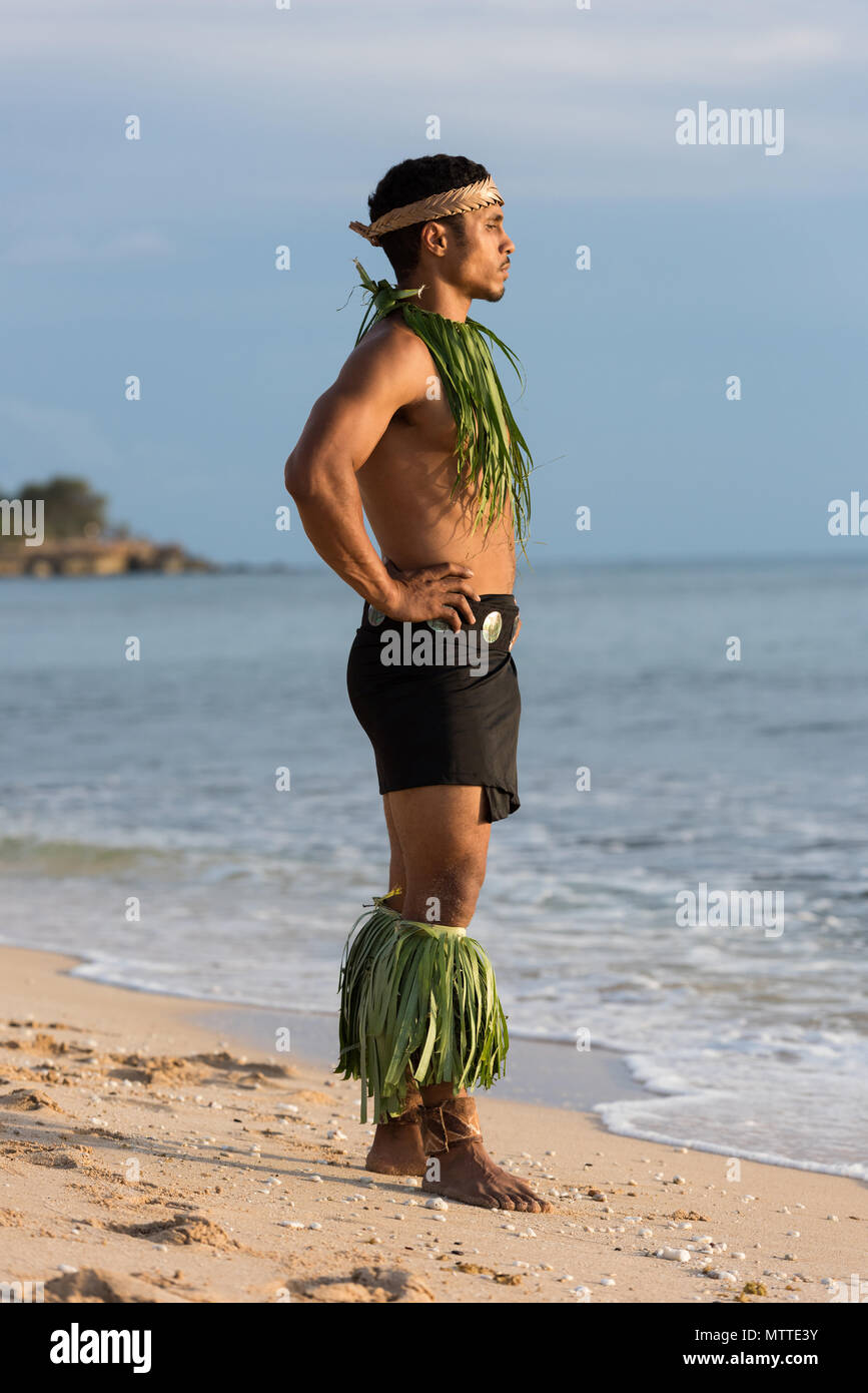 Male fire dancer standing with hands on hip at beach Stock Photo - Alamy