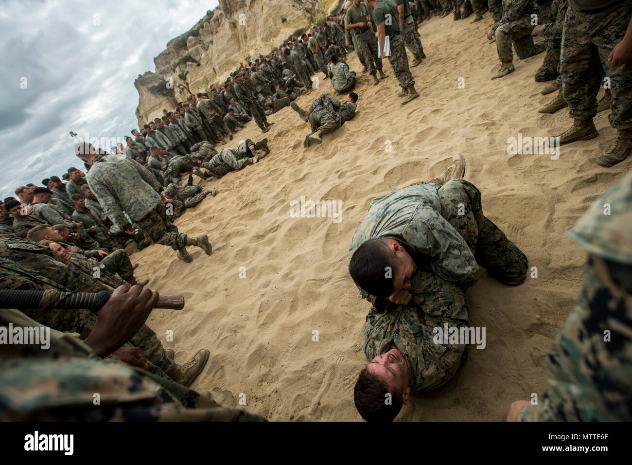 U.S. Marines, with 1st Light Armored Reconnaissance Battalion, 1st Marine Division, grapple ...