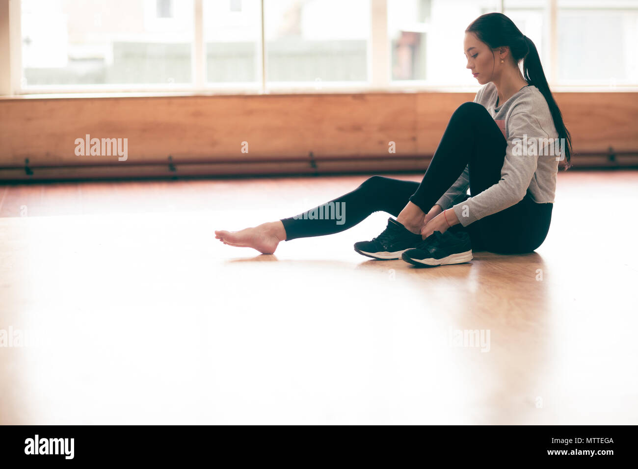 Female dancer wearing shoes in dance studio Stock Photo - Alamy