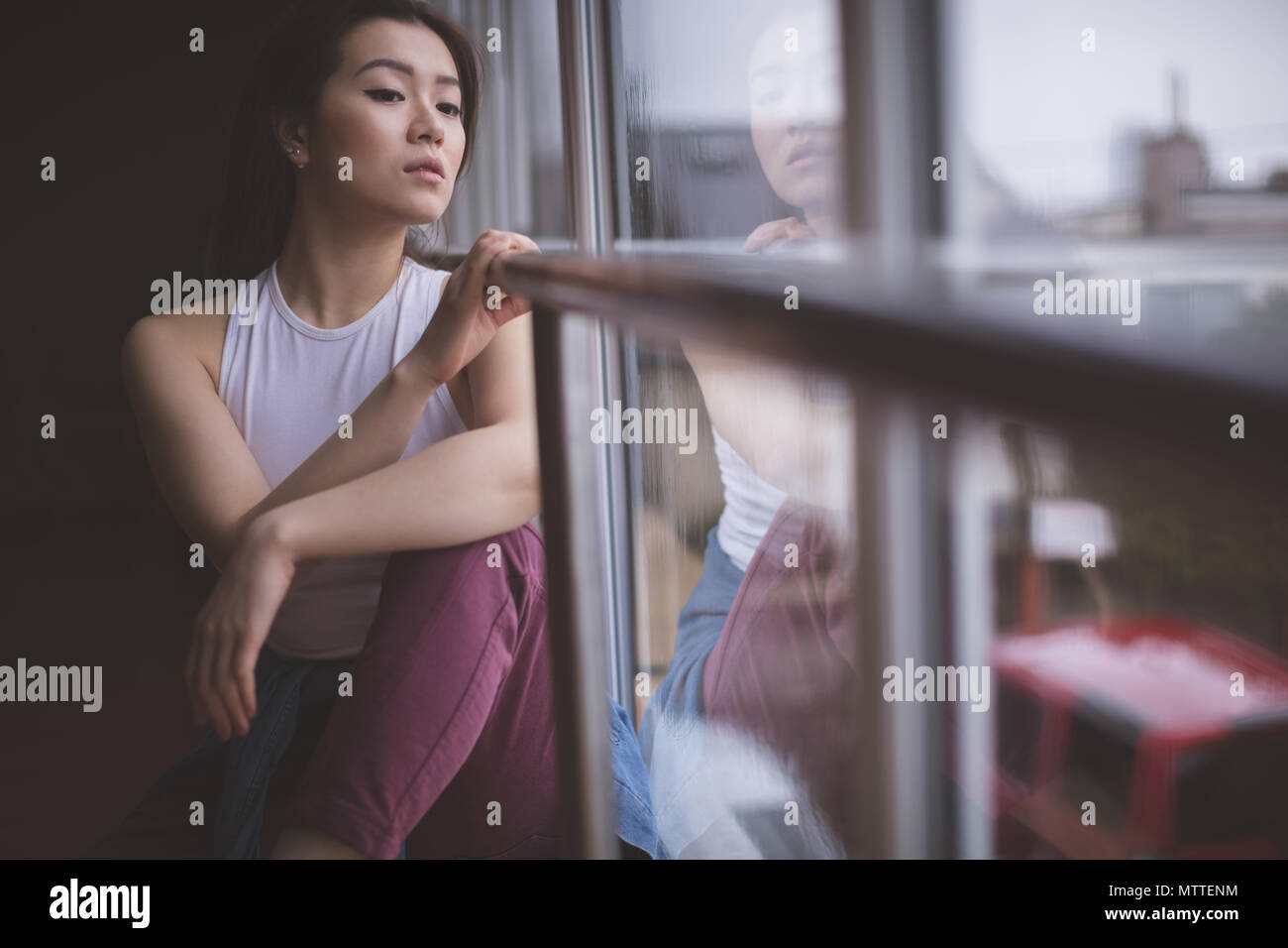Female dancer looking through window in dance studio Stock Photo - Alamy