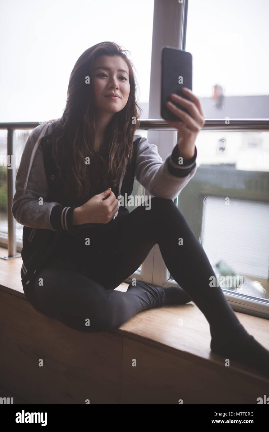 Female dancer taking selfie with mobile phone in dance studio Stock ...