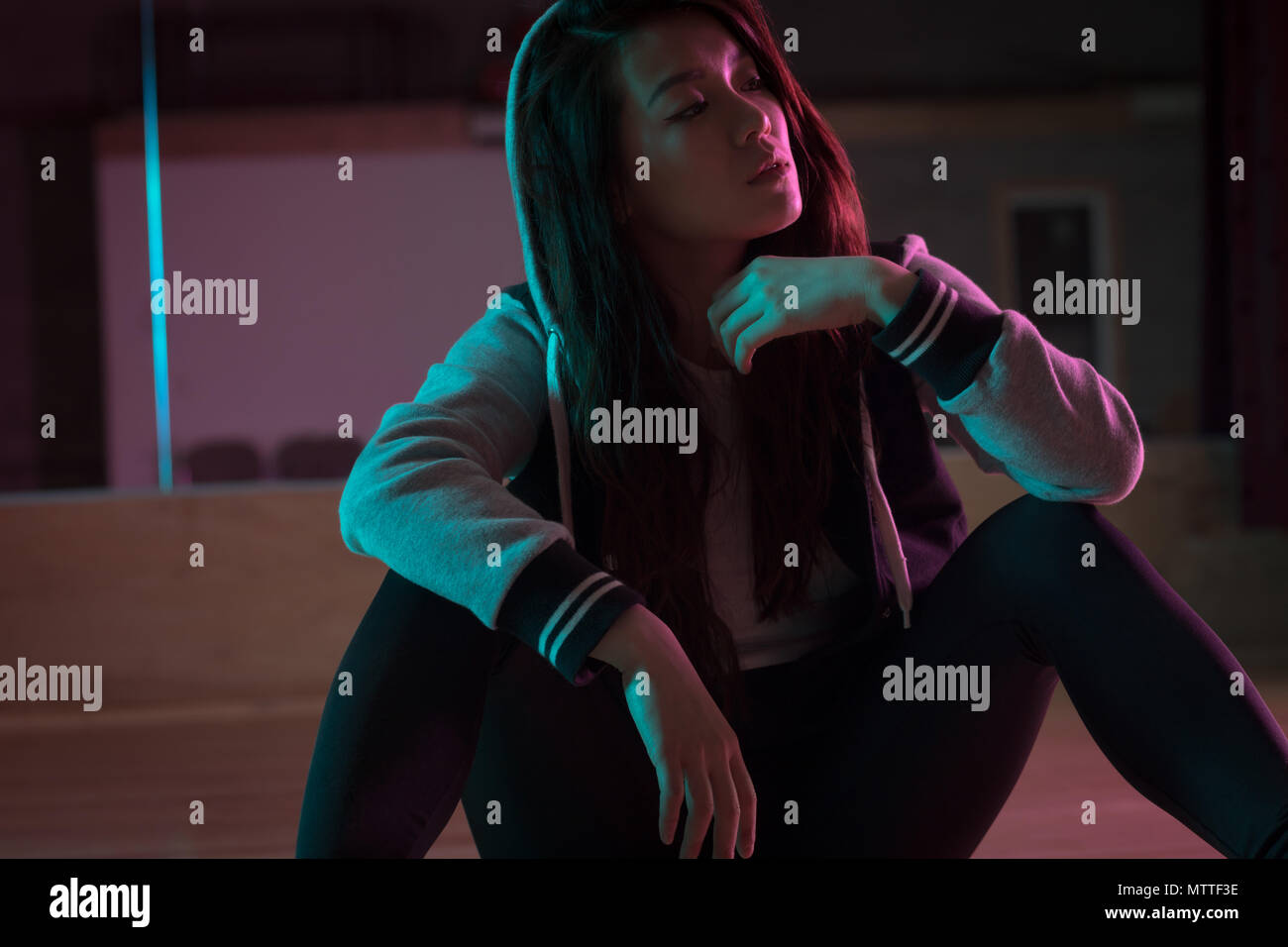 Female dancer relaxing in dance studio Stock Photo - Alamy