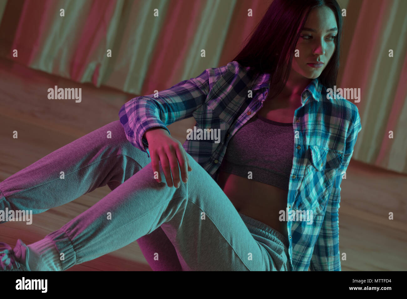 Female dancer relaxing in dance studio Stock Photo - Alamy