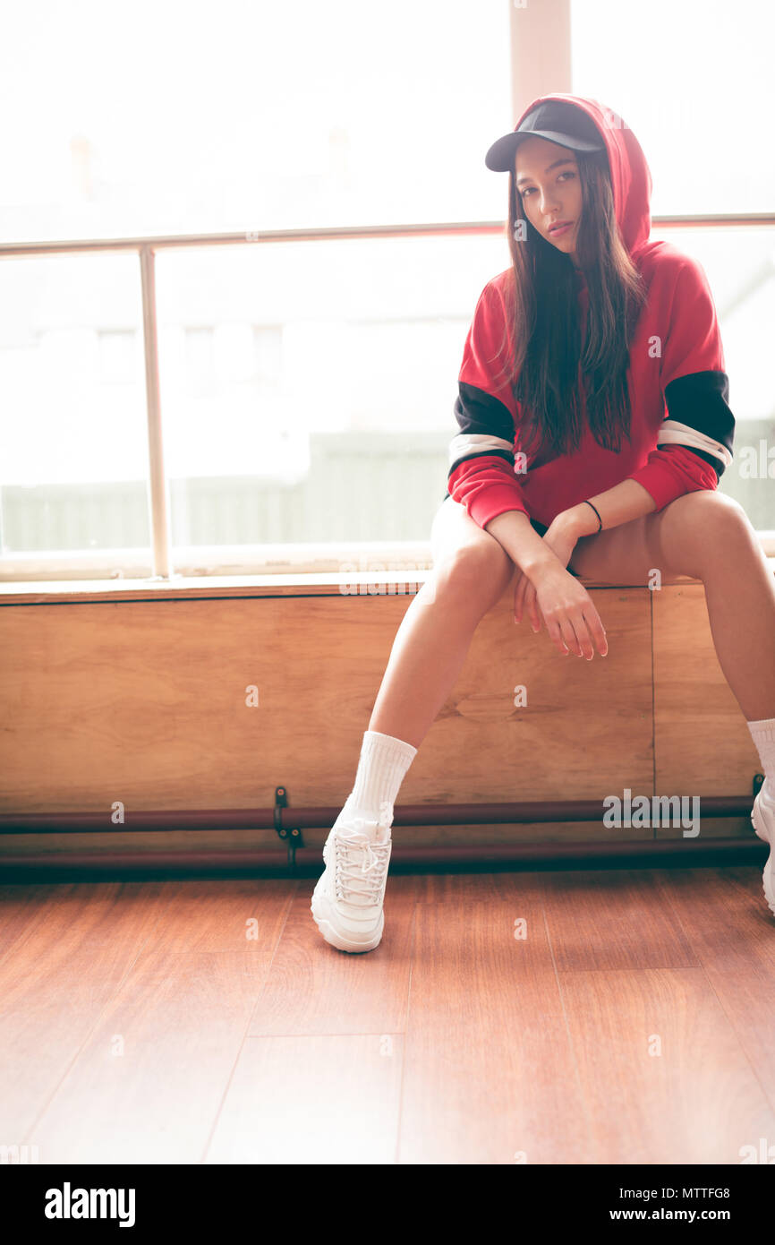 Female dancer relaxing near window in dance studio Stock Photo - Alamy